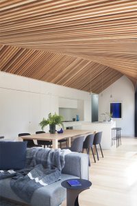 A roof that twists and sweeps bucks the single-story renovation trend