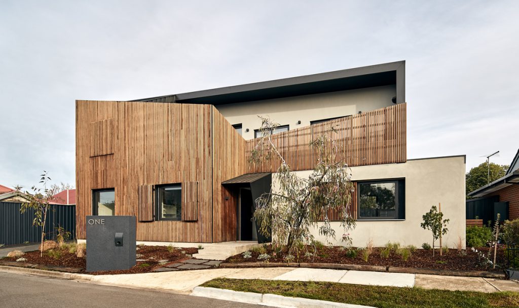 Timber screens give the illusion of a house bending toward the ground ...
