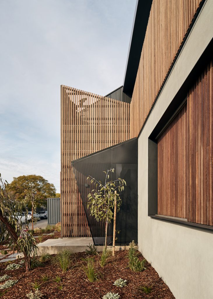 Timber screens give the illusion of a house bending toward the ground ...